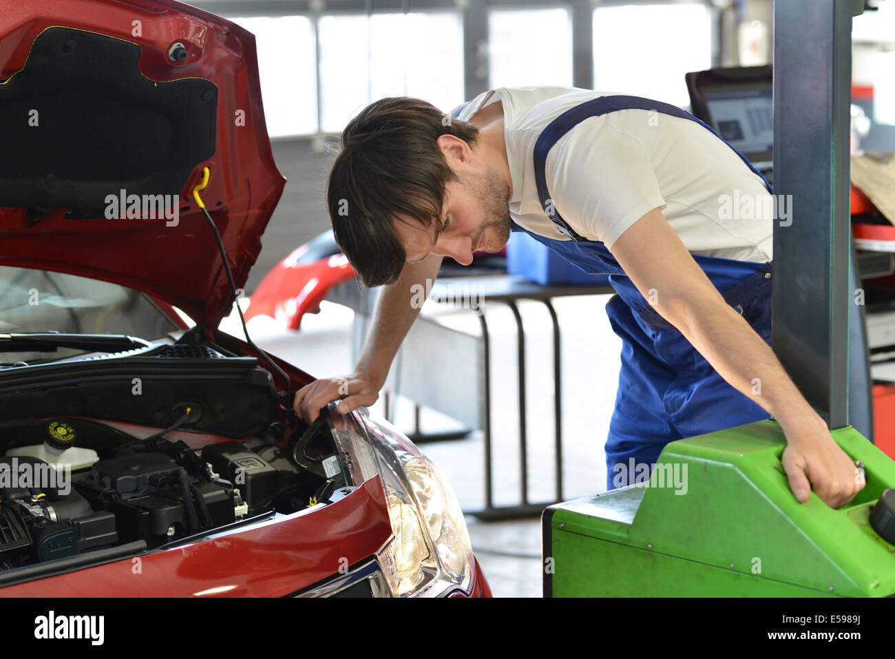 Car mechanic adjusting headlight Stock Photo - Alamy