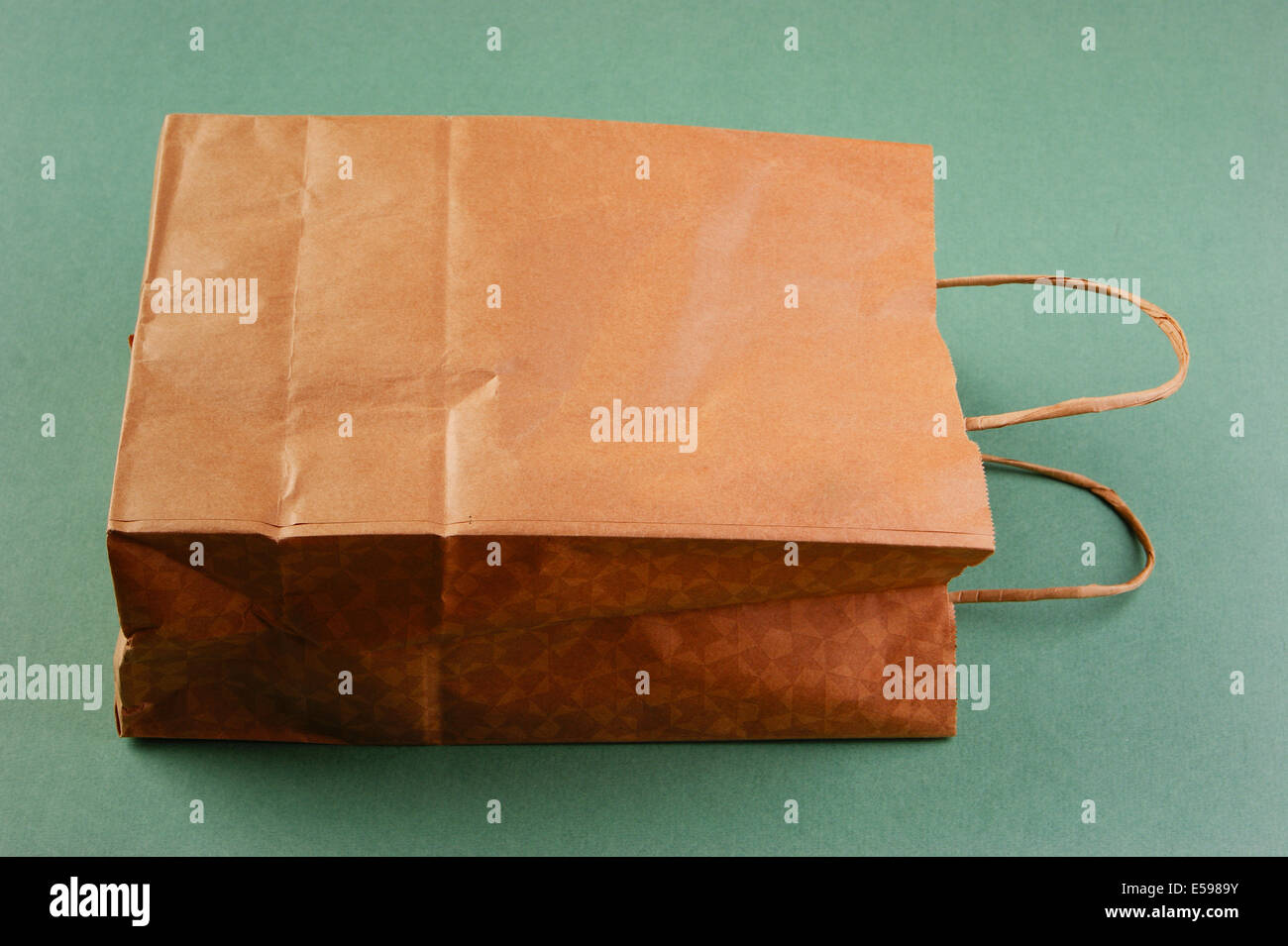 paper bag on a green background Stock Photo - Alamy