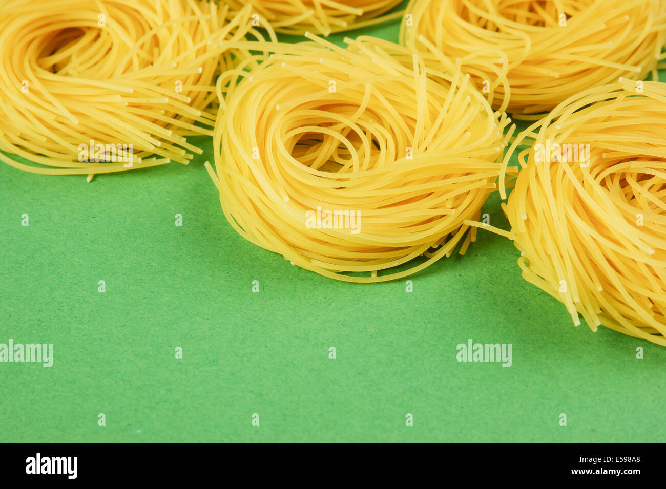 Tagliatelle pasta background on the green background Stock Photo - Alamy