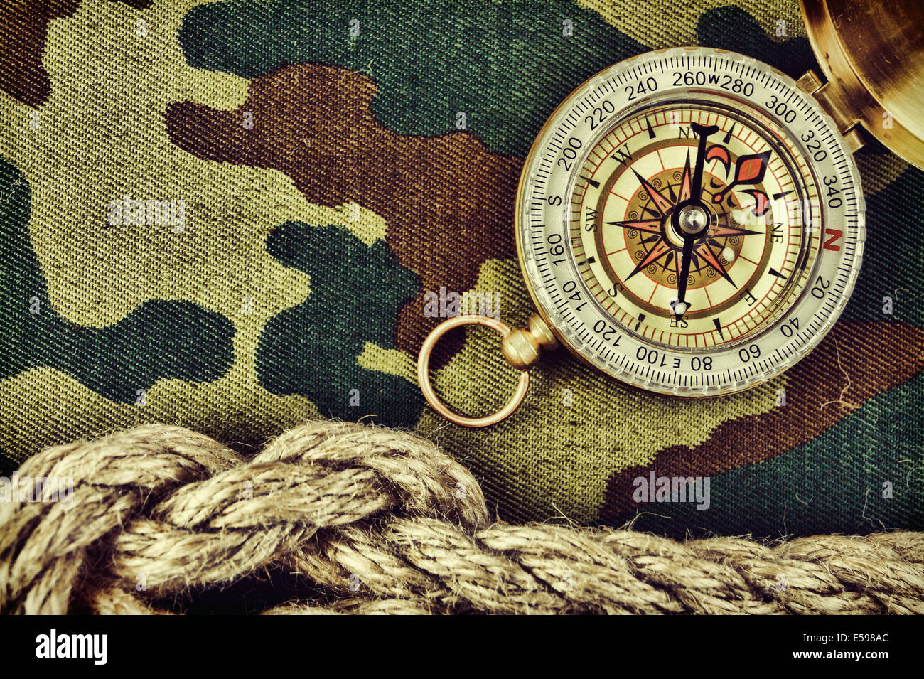 Compass and rope on a camouflage background Stock Photo - Alamy