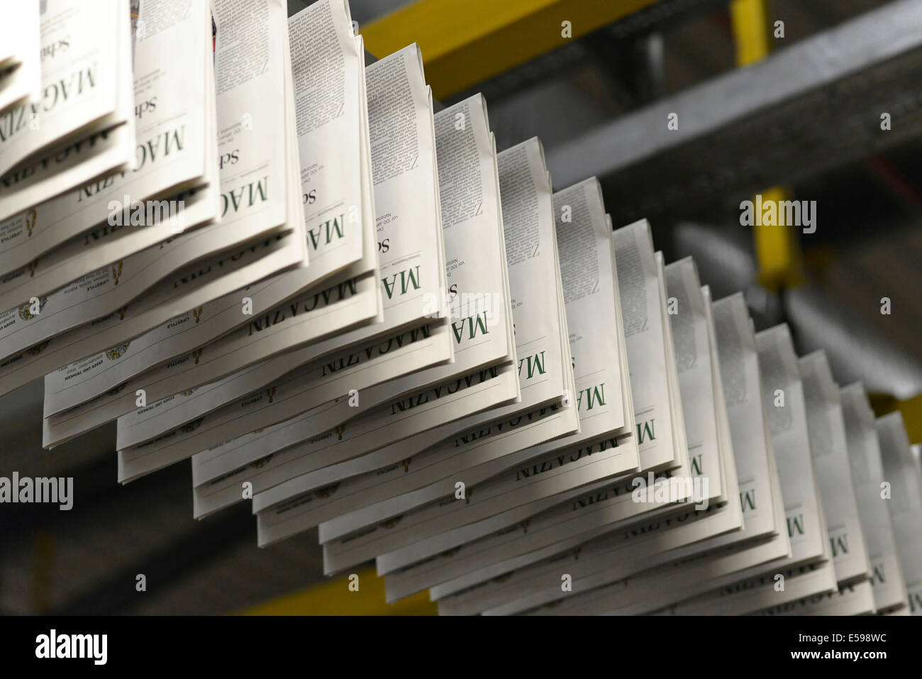 Conveyor belt with printed newspapers in a printing shop Stock Photo ...