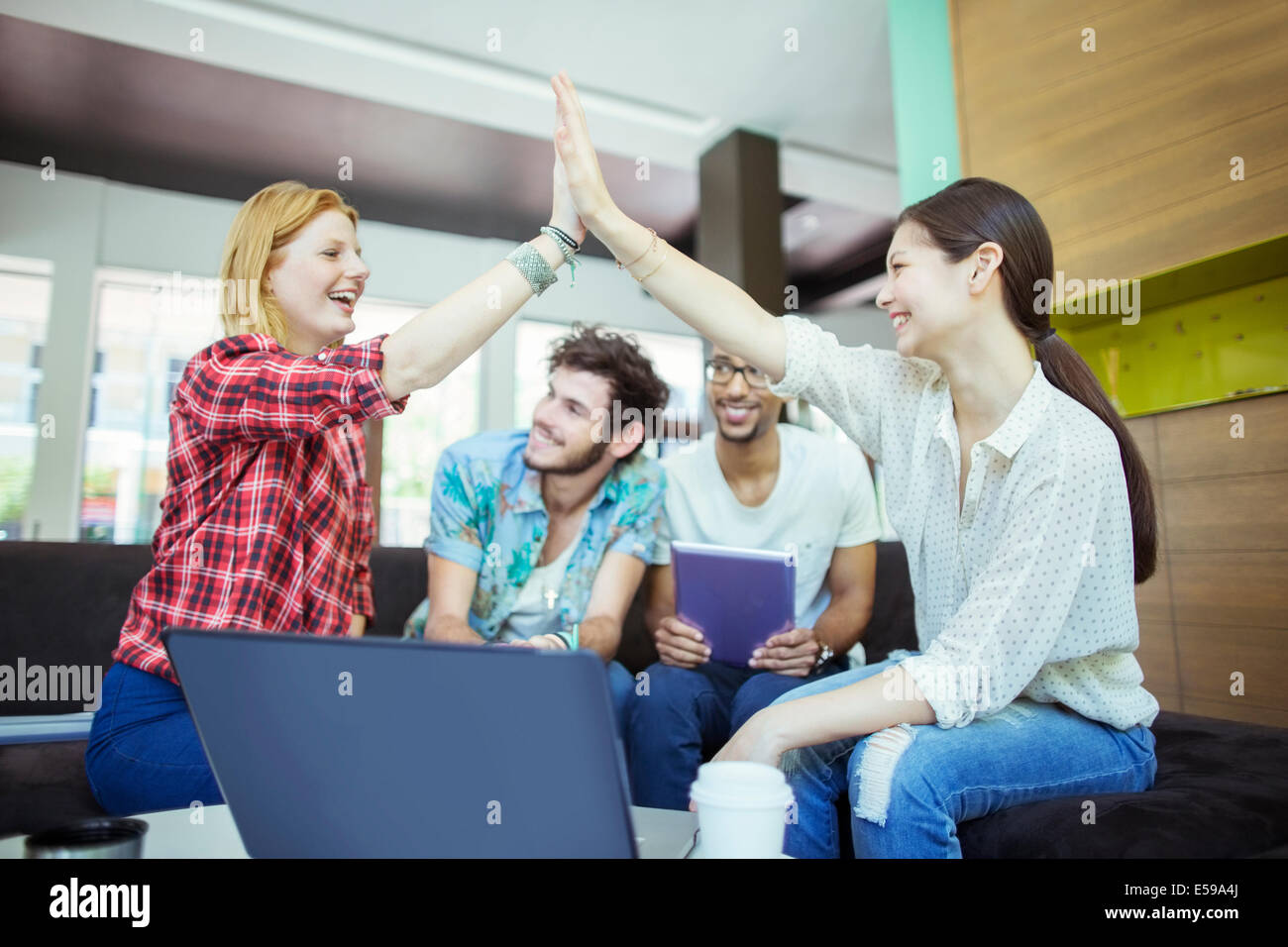 People high fiving in office Stock Photo - Alamy