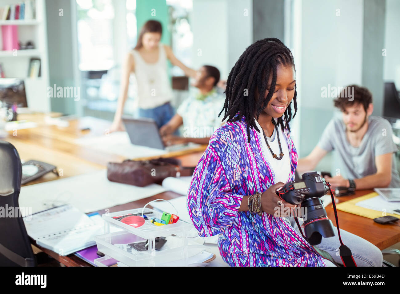 People reviewing photos in office Stock Photo - Alamy