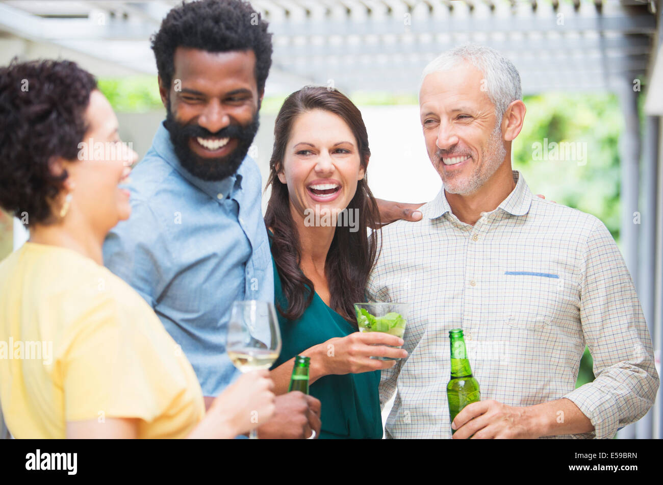 Friends laughing at party Stock Photo - Alamy