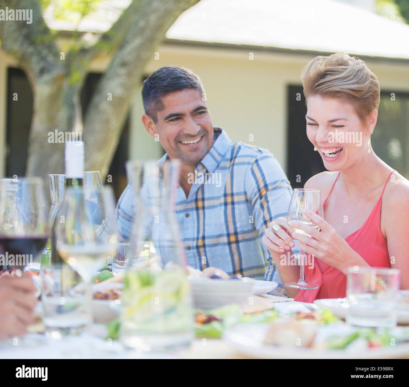 People laughing at dinner table hi-res stock photography and images - Alamy