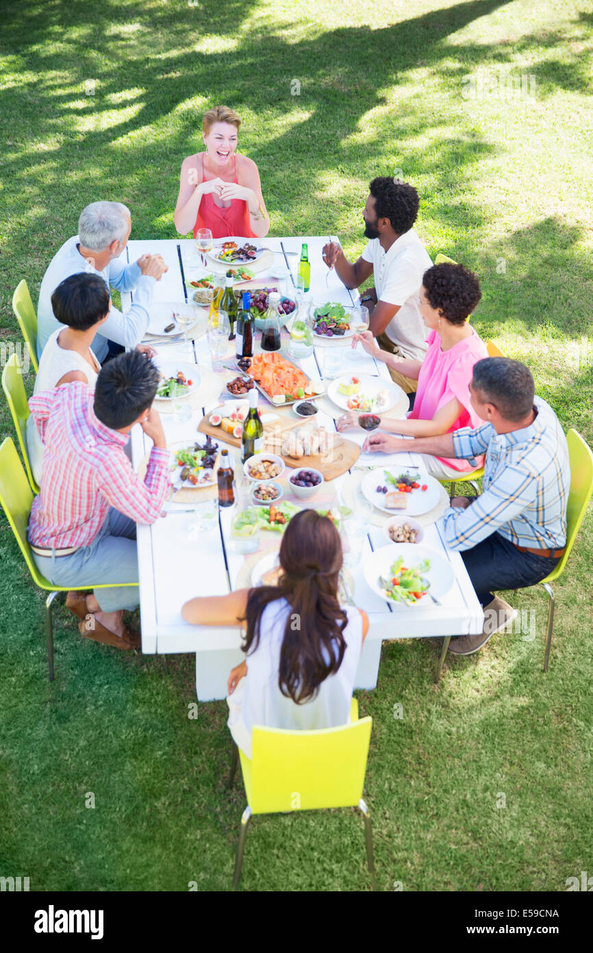 Friends eating together at table outdoors Stock Photo - Alamy