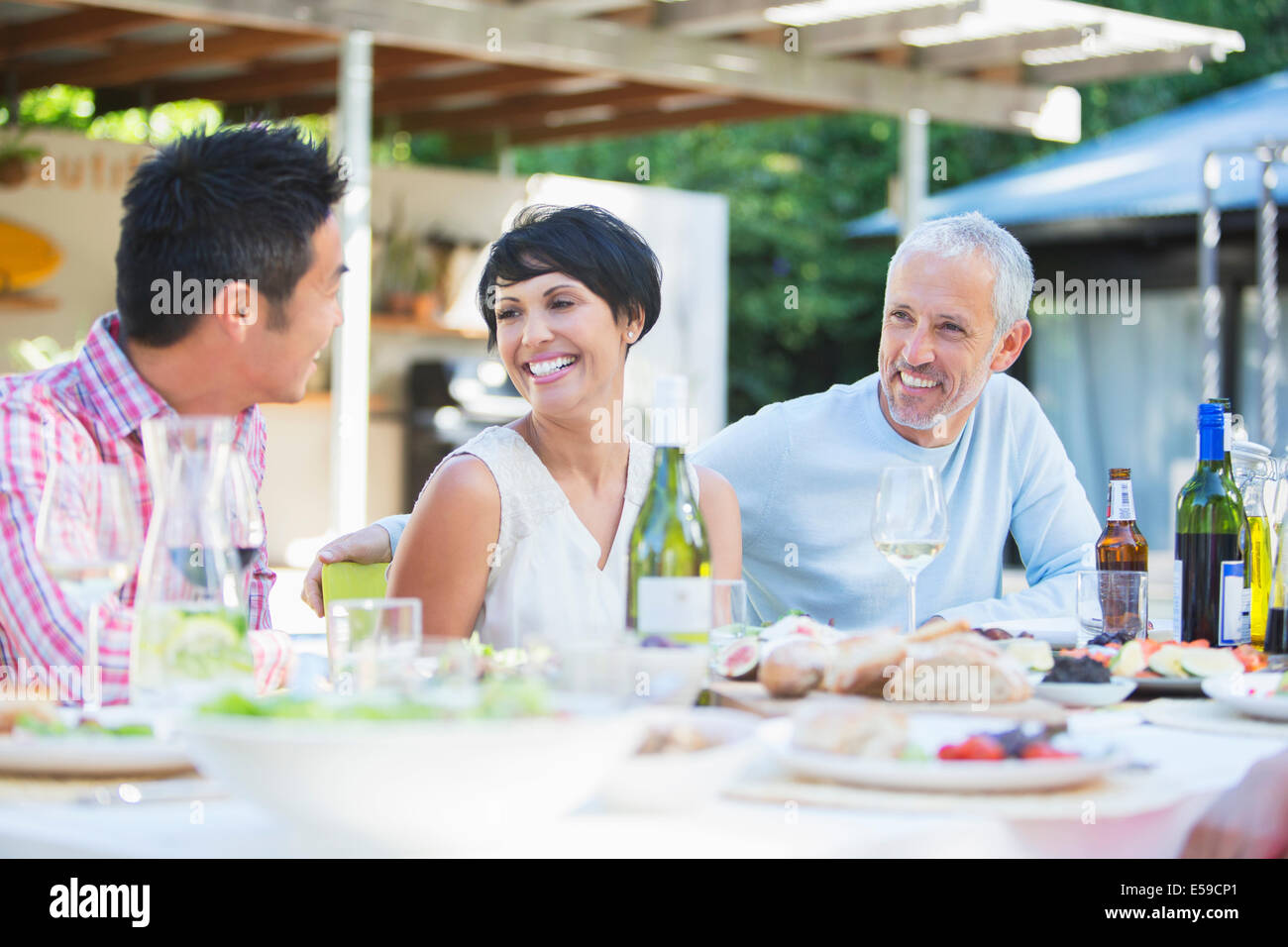 Friends relaxing at table outdoors Stock Photo - Alamy