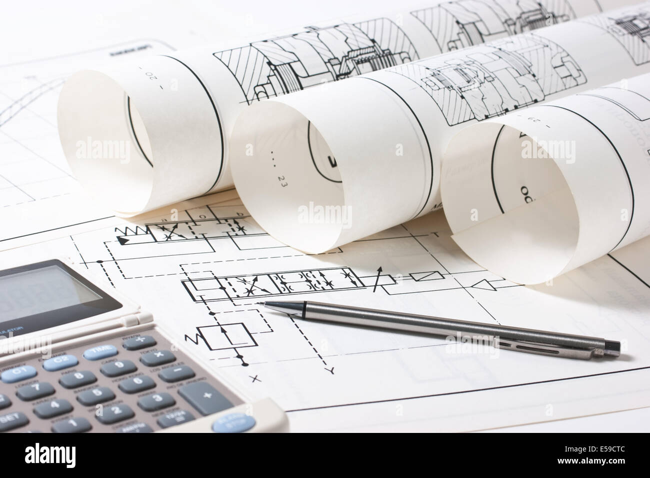 rolled technical drawings and a calculator Stock Photo - Alamy