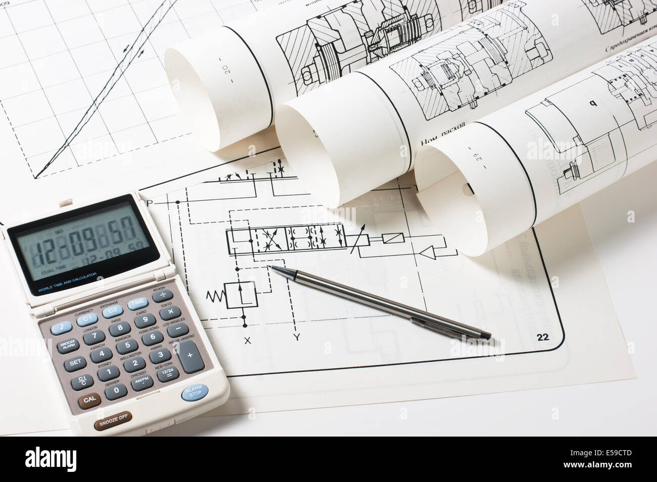 rolled technical drawings and a calculator Stock Photo - Alamy