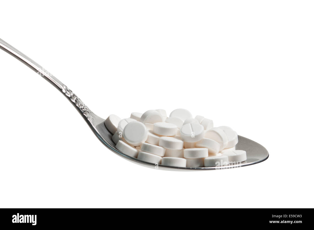 pills in a spoon isolated on white background Stock Photo - Alamy