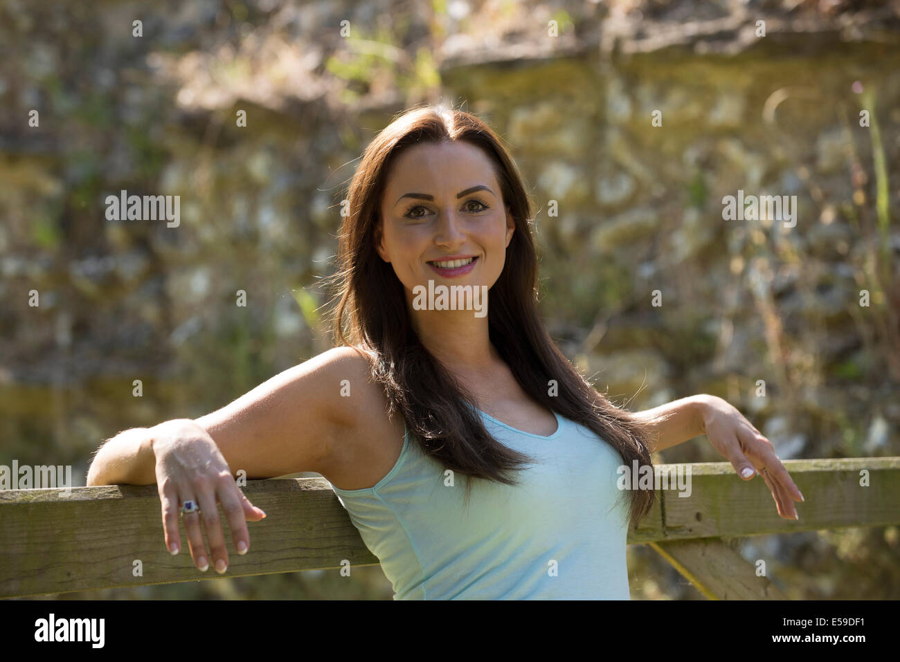Woman leaning on gate hi-res stock photography and images - Alamy