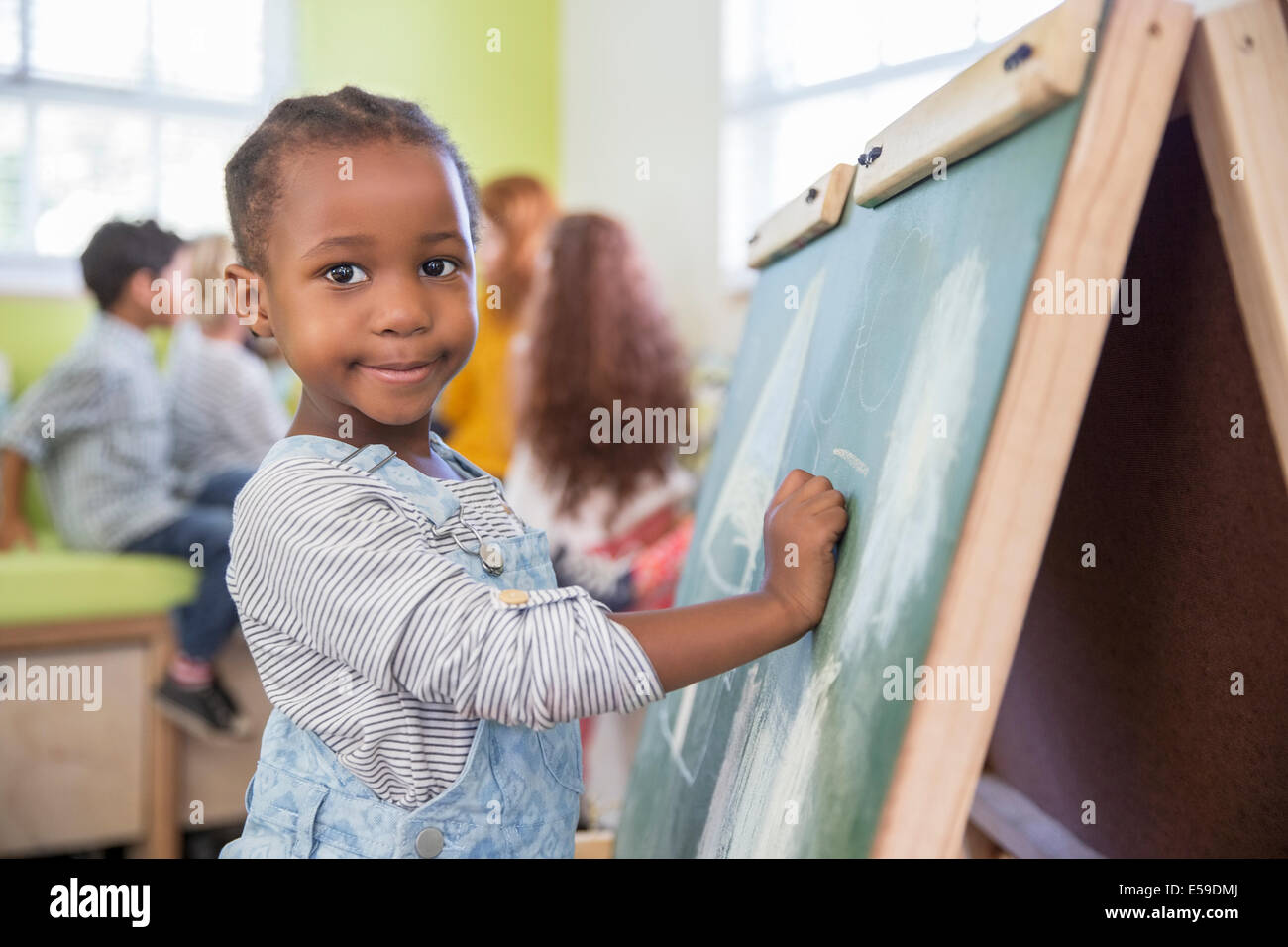 Girl drawing on chalkboard in classroom Stock Photo - Alamy