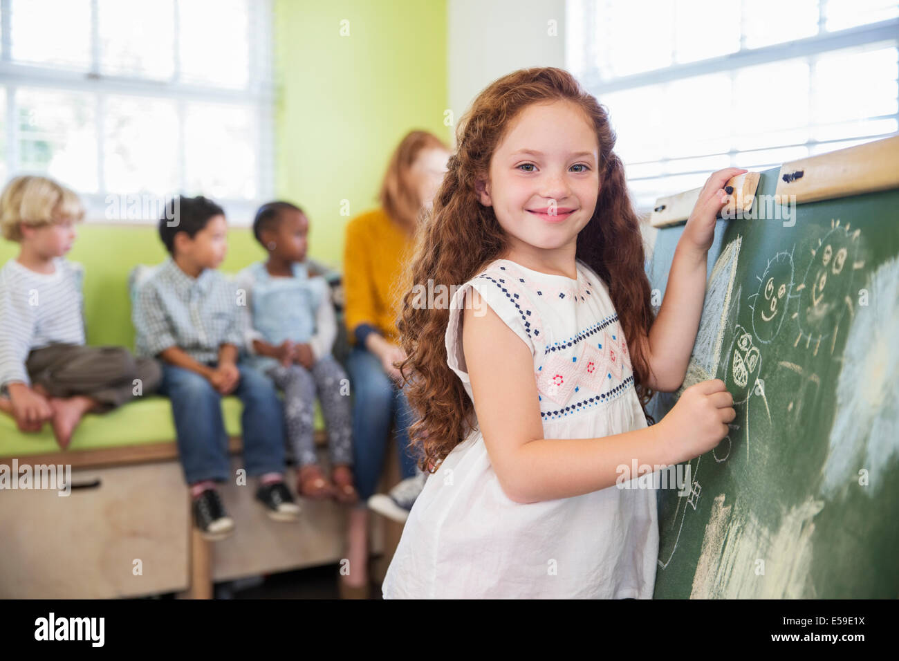 Student drawing on chalkboard in classroom Stock Photo - Alamy