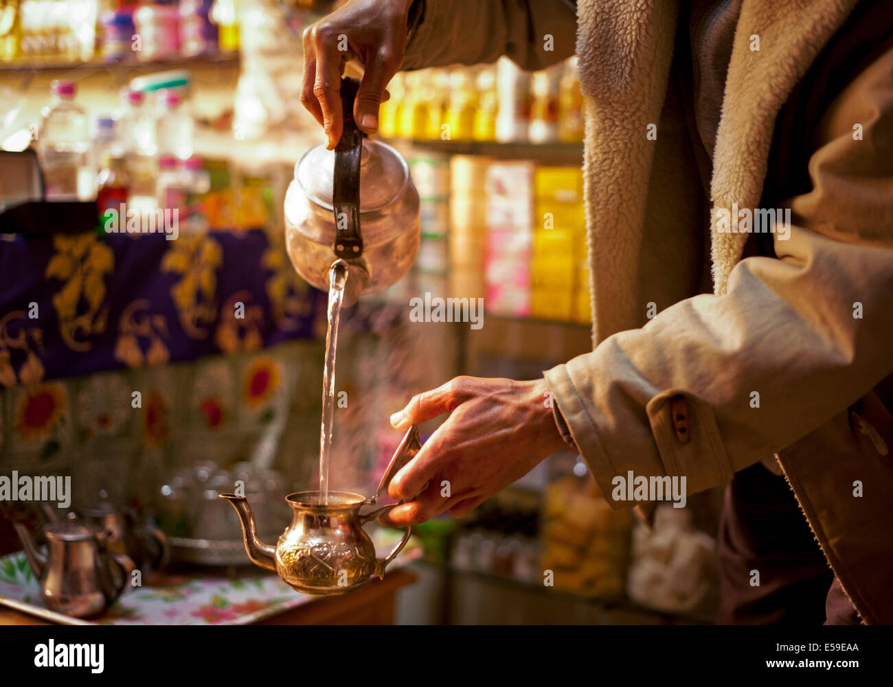 Moroccan tea pouring in market place Stock Photo - Alamy