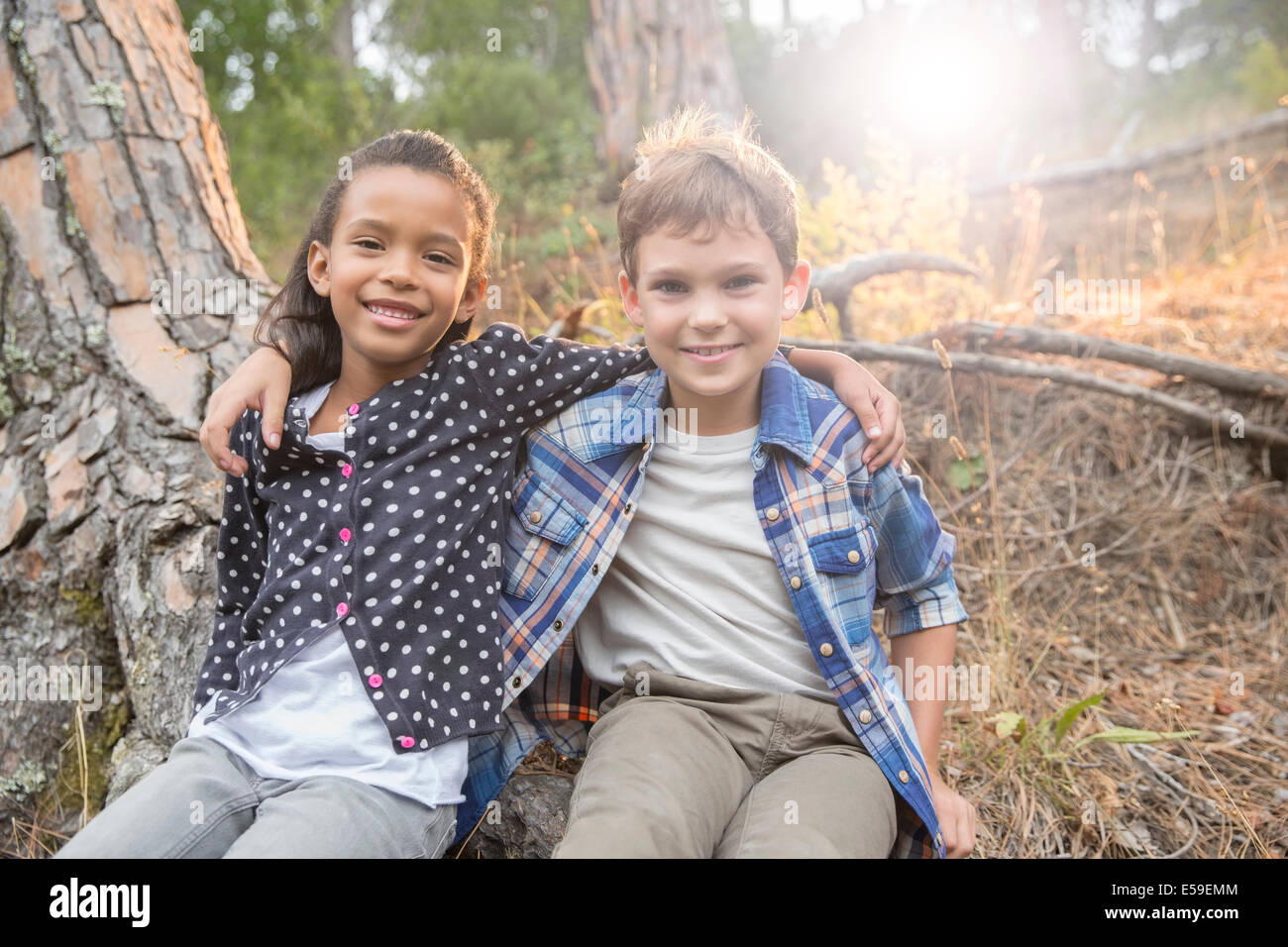 Children sitting together outdoors Stock Photo - Alamy