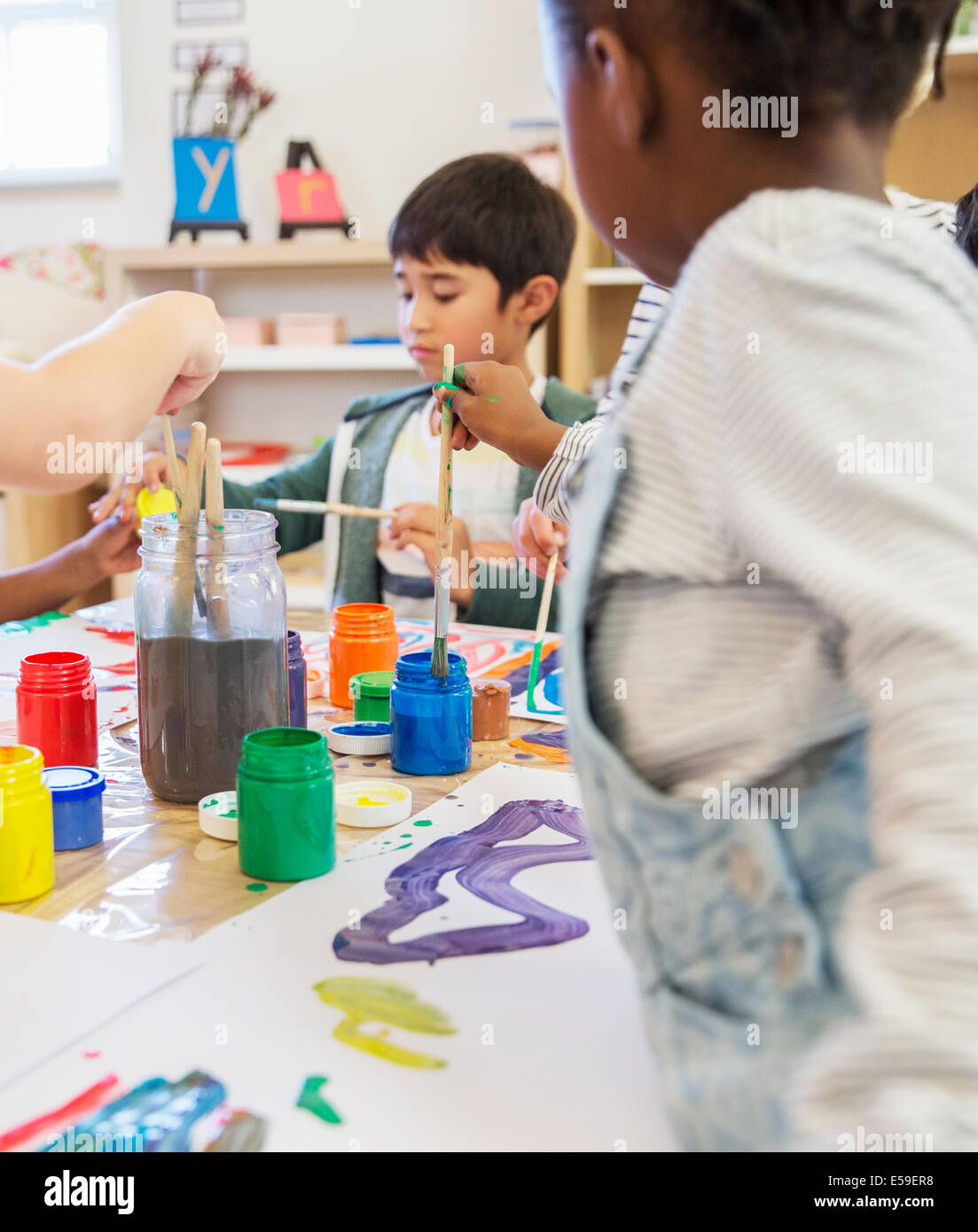 Students painting in classroom Stock Photo - Alamy