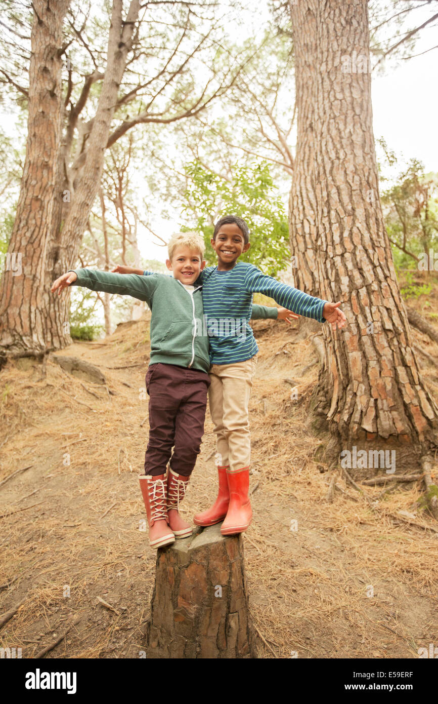 Children climbing on stump in forest Stock Photo - Alamy