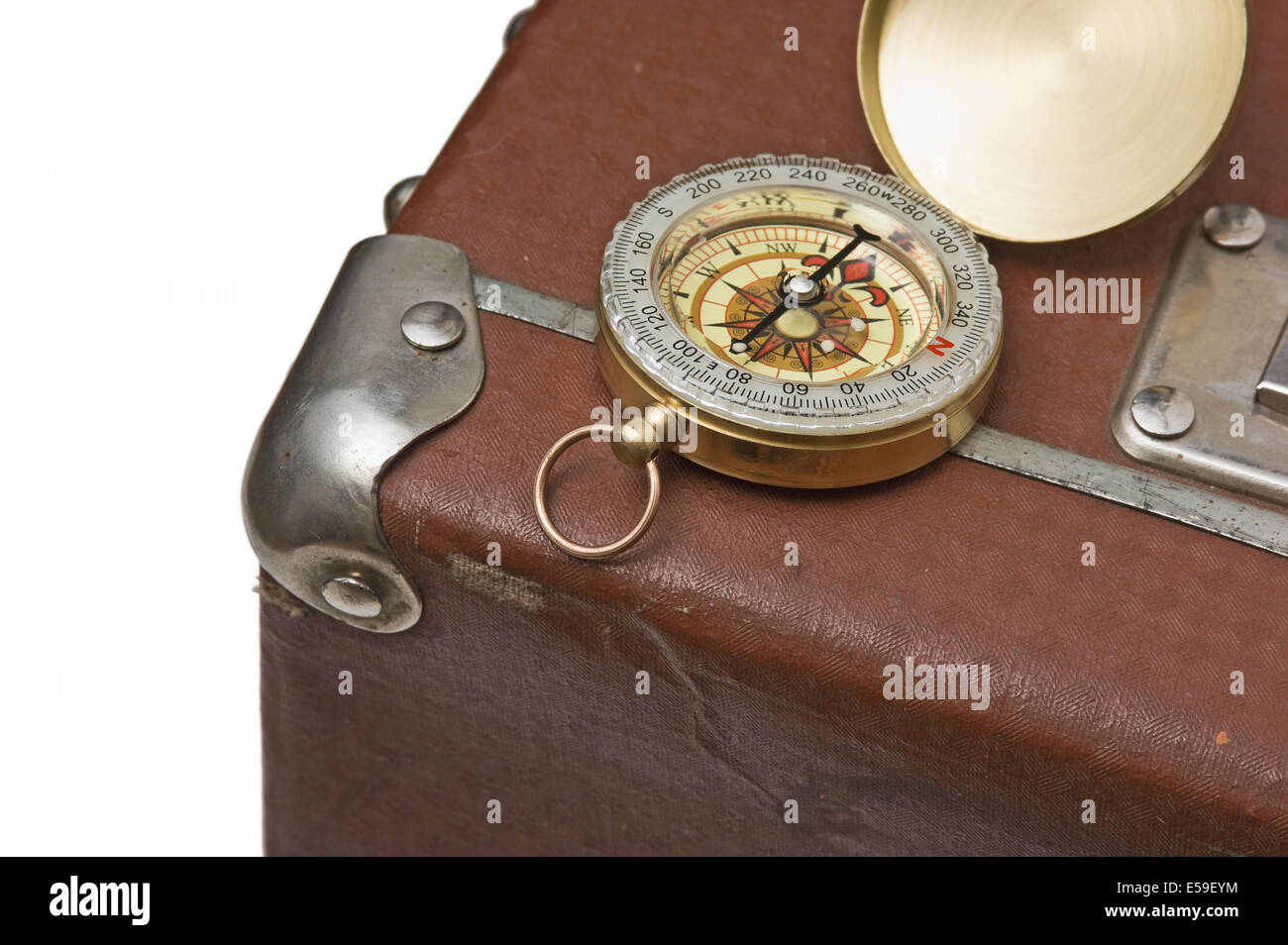 old suitcase and compass isolated on white background Stock Photo - Alamy