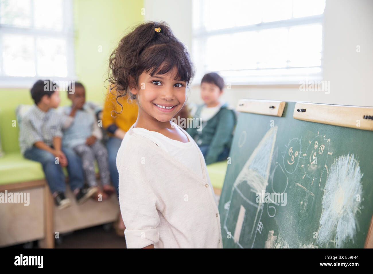 Student drawing on chalkboard in classroom Stock Photo - Alamy