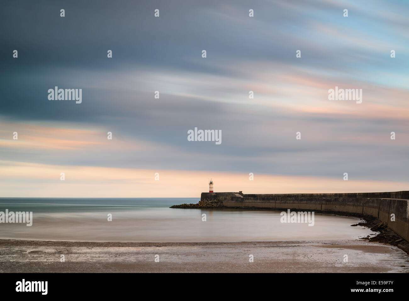 Stunning long exposure landscape lighthouse at sunset with calm sea ...