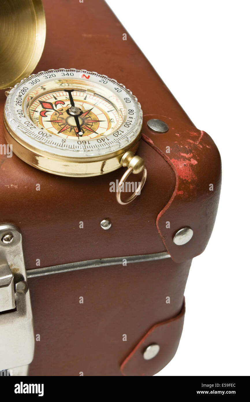 old suitcase and compass isolated on white background Stock Photo - Alamy
