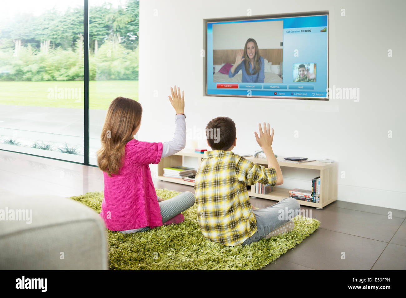 Children video chatting on television in living room Stock Photo - Alamy