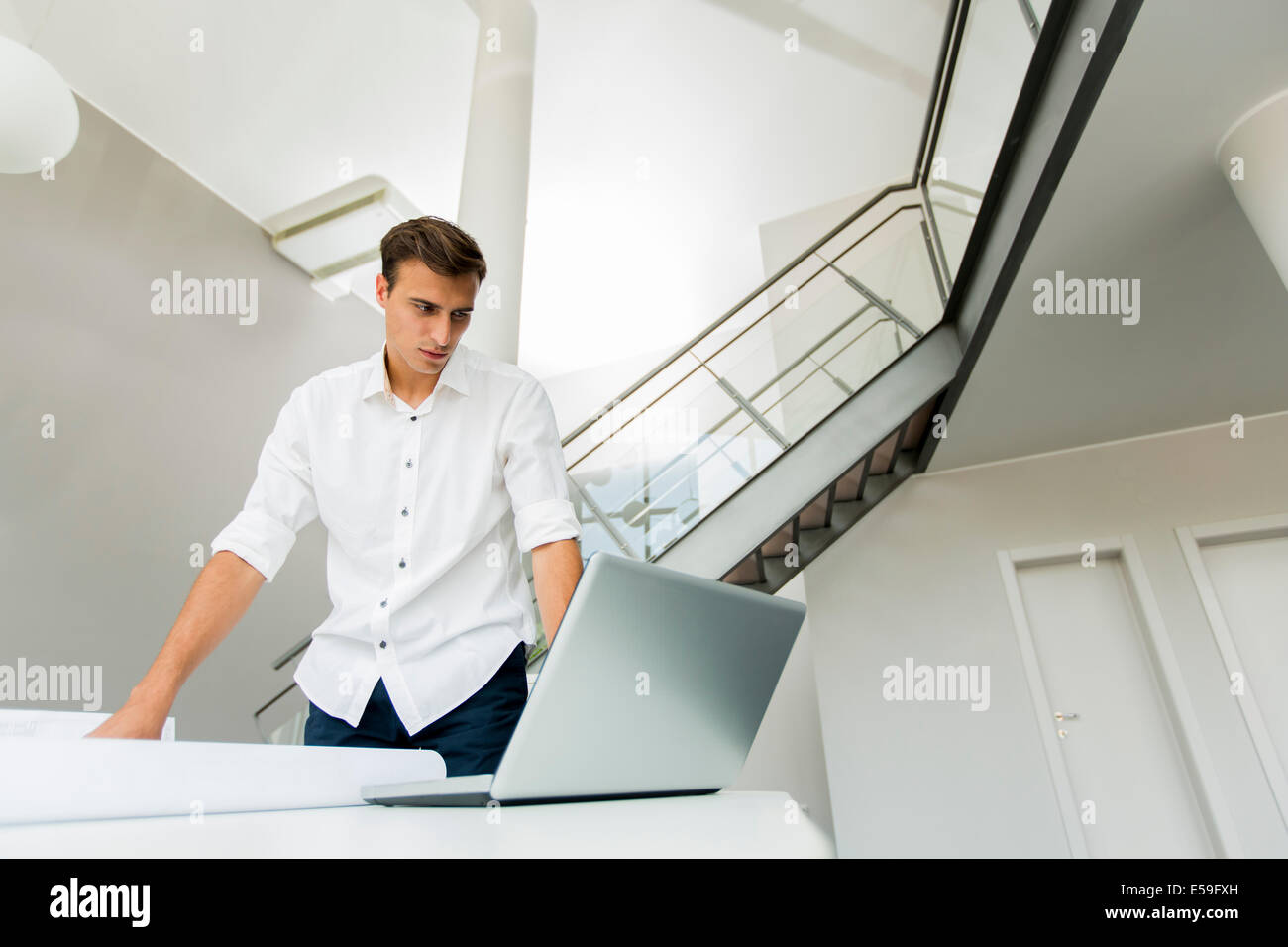Young man in the office Stock Photo - Alamy