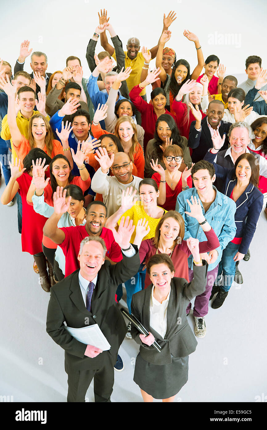 Portrait of diverse workers waving Stock Photo - Alamy