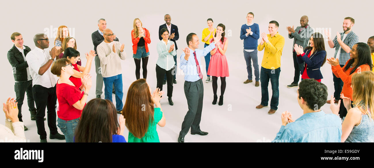 Crowd cheering for businessman Stock Photo - Alamy