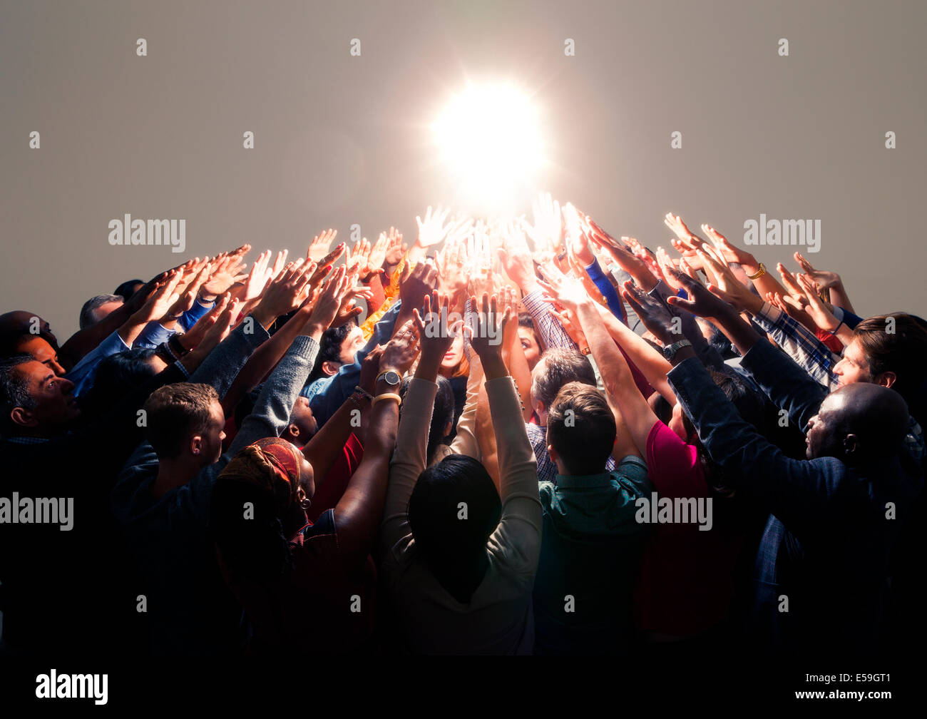 Diverse crowd reaching bright light hi-res stock photography and images - Alamy