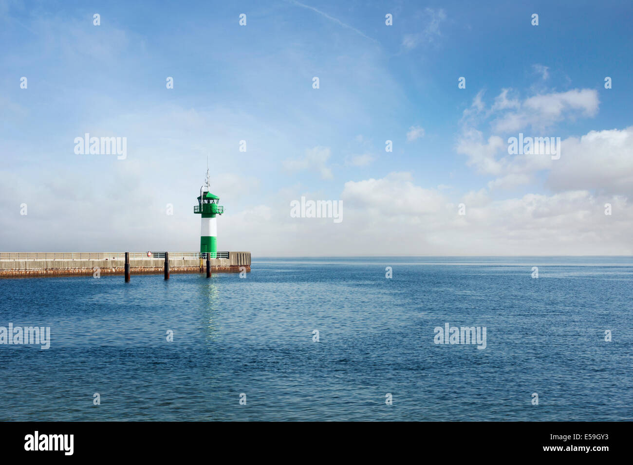 Pier with green Lighthouse Stock Photo - Alamy