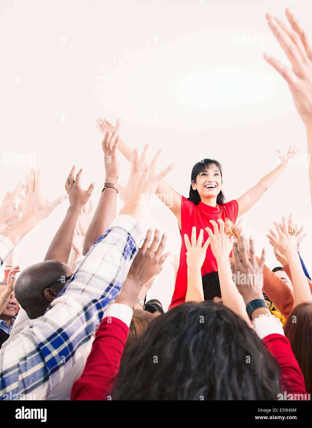 Business people cheering for businesswoman Stock Photo - Alamy