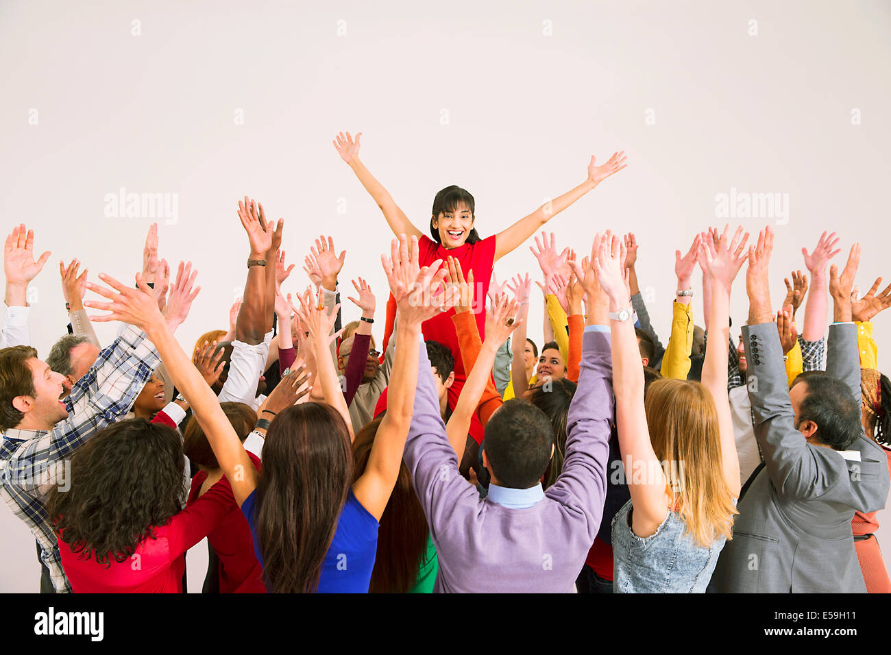 Business people cheering for businesswoman Stock Photo - Alamy