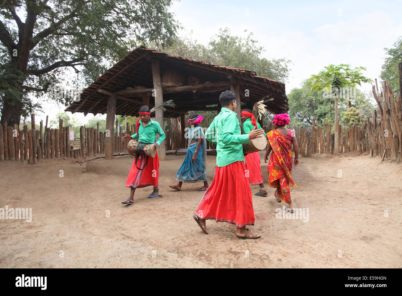 Tribal people performing a typical tribal dance in traditional outfits ...