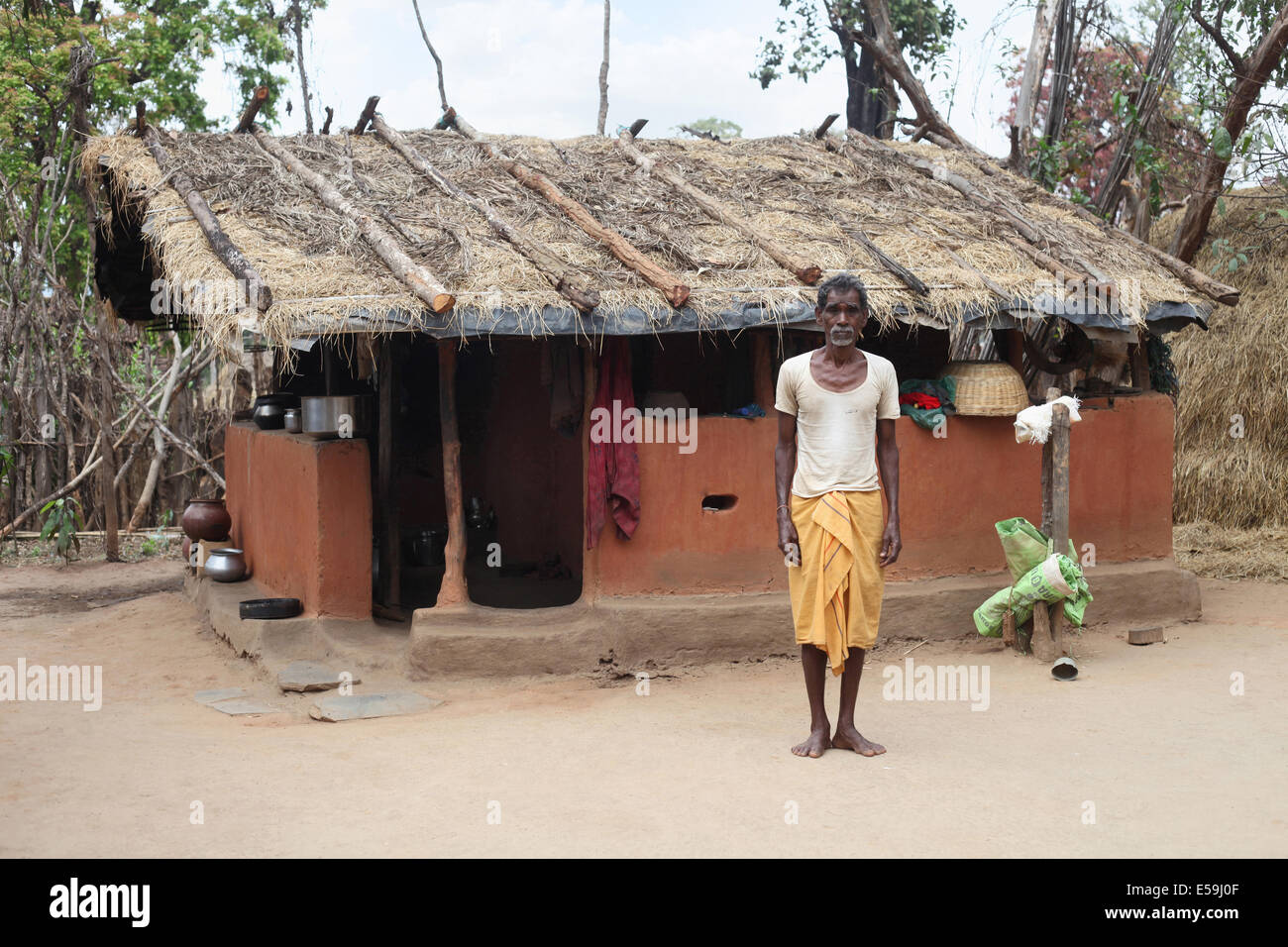 Tribal Man standing in front of his house, Bhunjiya tribe, Kodopali ...