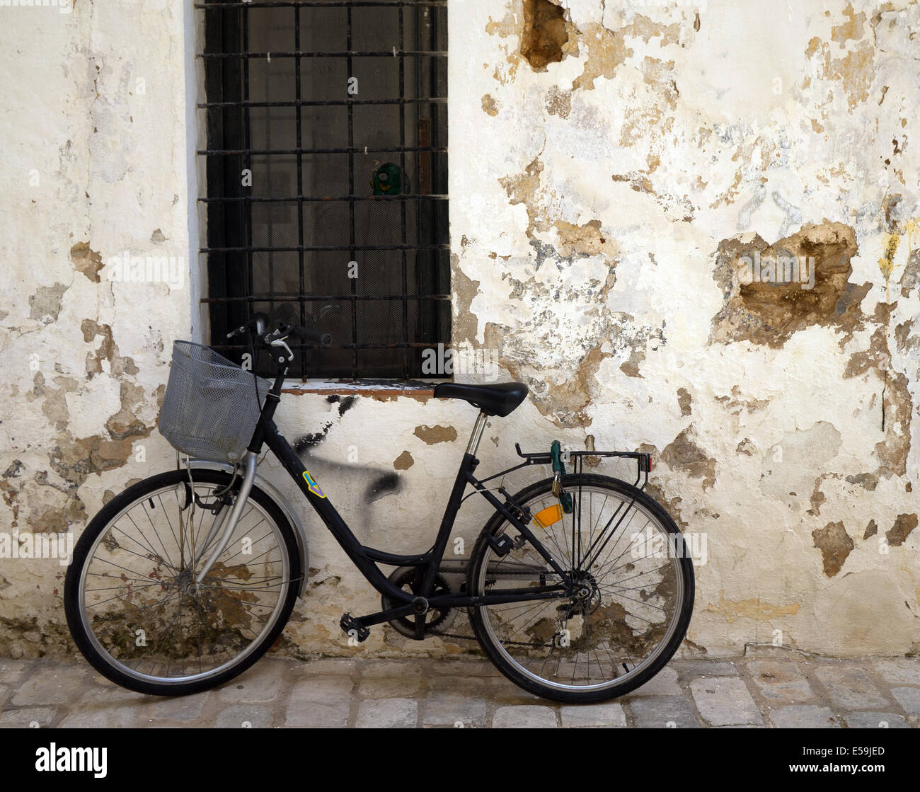 Traditional bicycle leaning against a rustic, crumbling ,white-washed ...