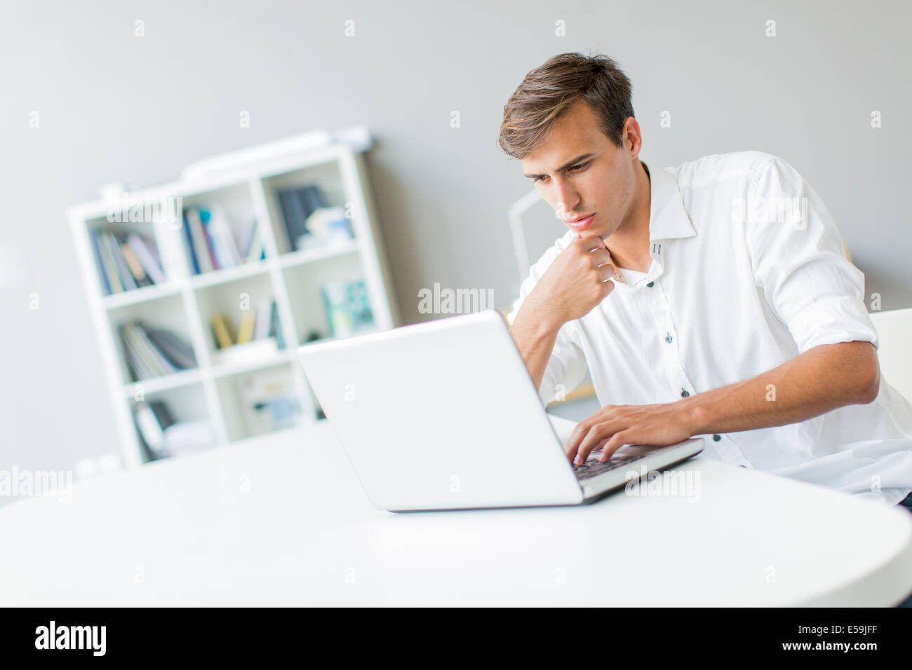 Young man in the office Stock Photo - Alamy