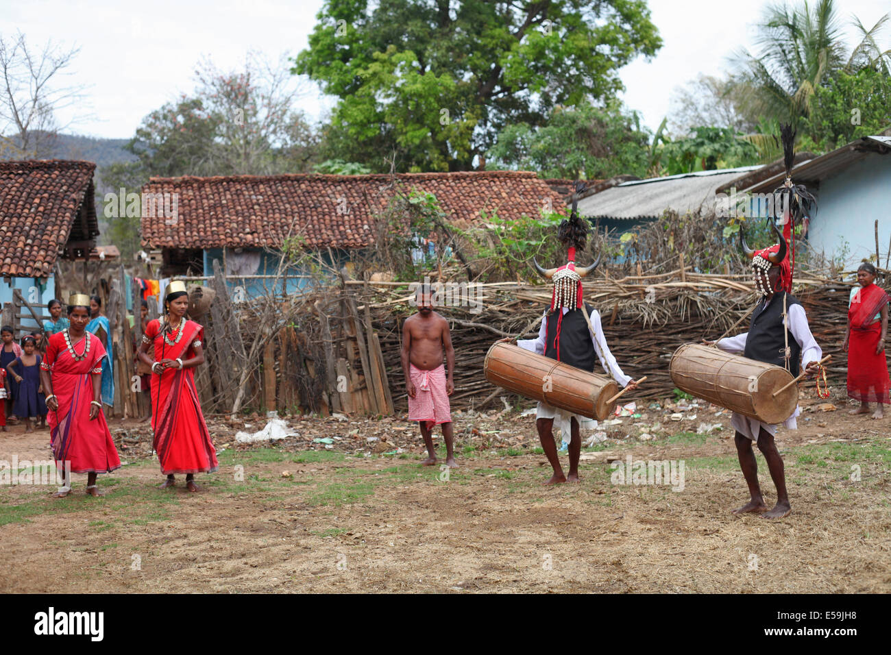 Tribal people performing a typical tribal dance in traditional outfits ...