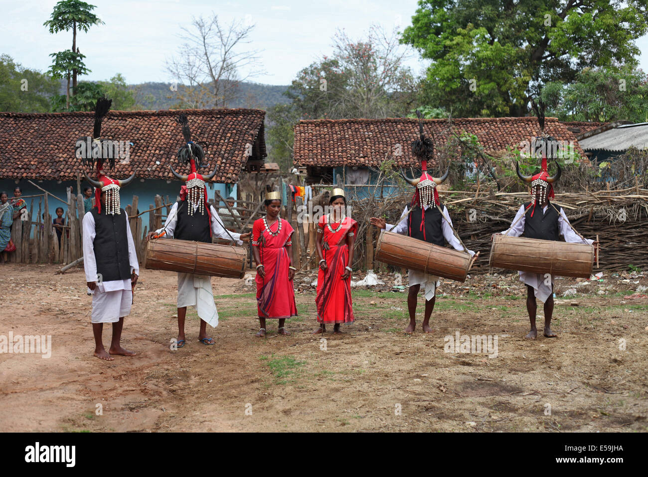 Tribal people performing a typical tribal dance in traditional outfits ...