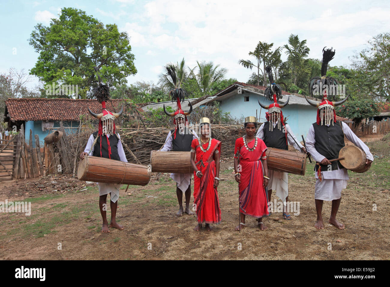 Tribal people performing a typical tribal dance in traditional outfits ...