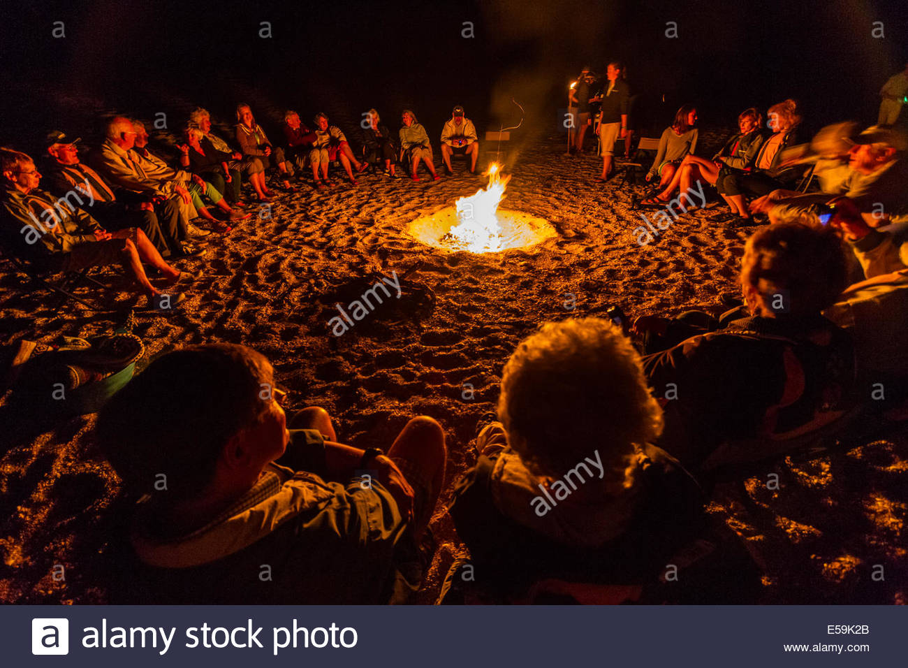 People Sitting Around Camp Fire Stock Photos & People Sitting Around ...