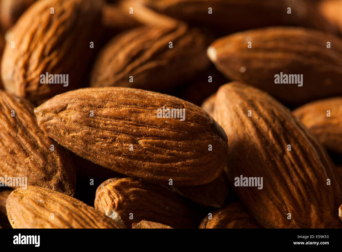 Raw Organic Brown Almonds in a Bowl Stock Photo - Alamy