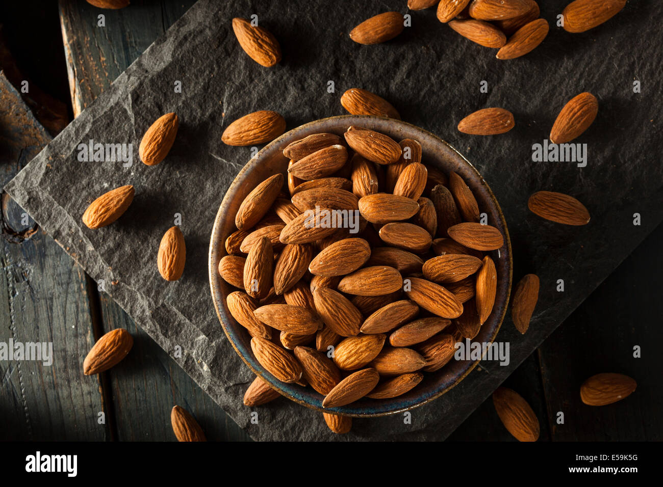 Raw Organic Brown Almonds in a Bowl Stock Photo - Alamy