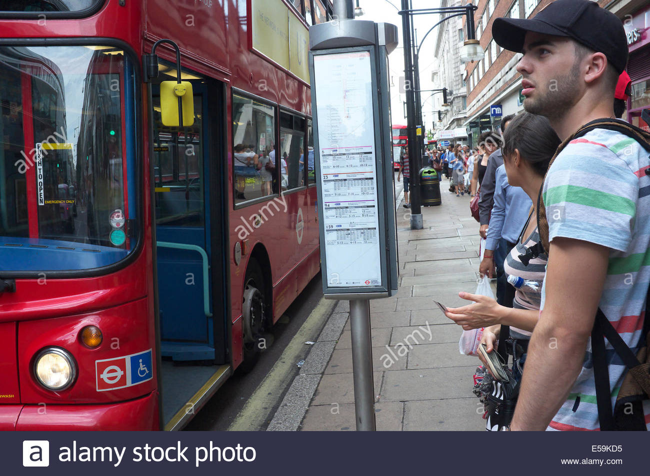 Queue Of People At Bus Stop High Resolution Stock Photography and ...