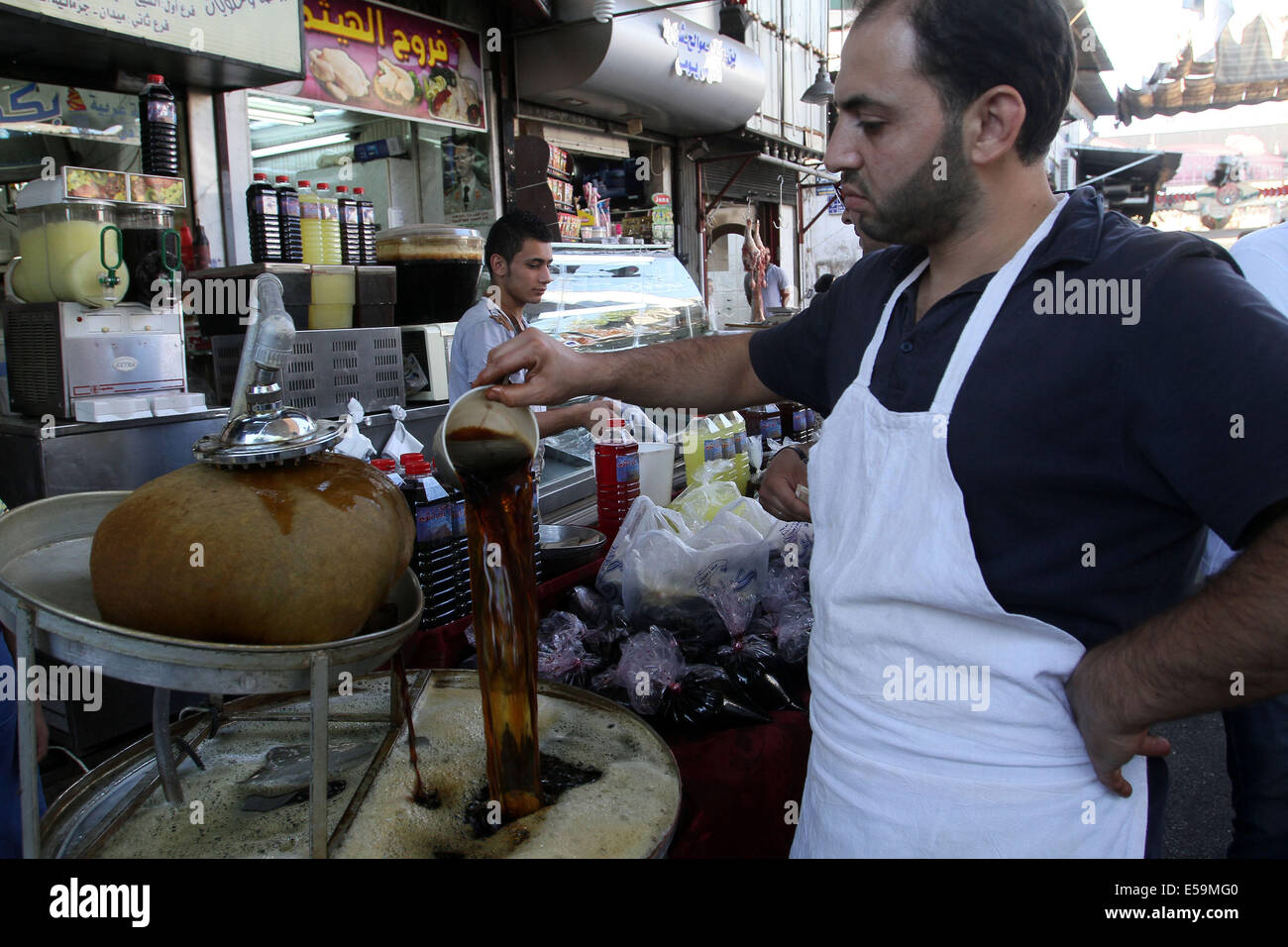 Damascus, Syria. 24th July, 2014. A Syrian man makes Arabic sweets in ...