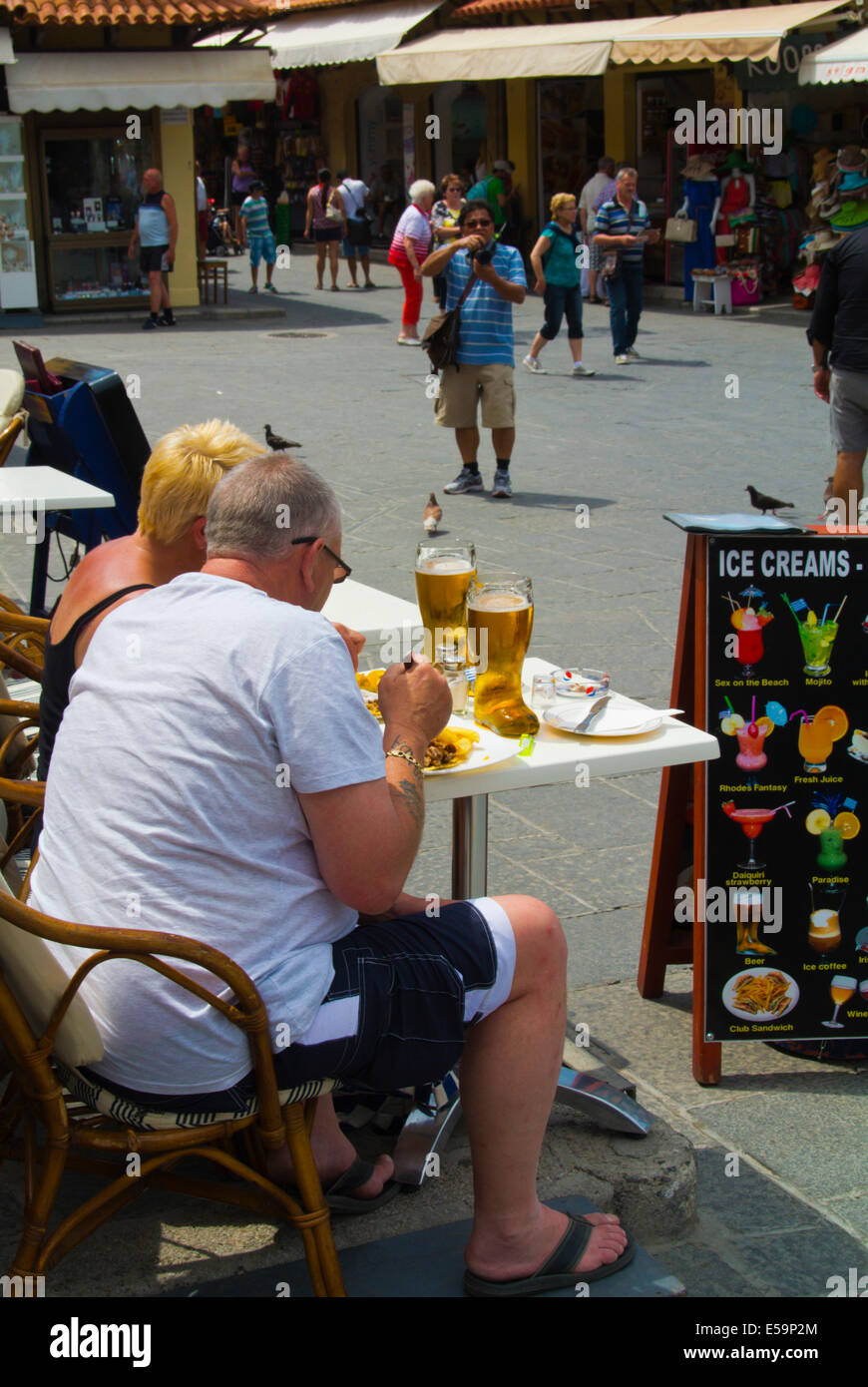 Tourists eating and drinking, Hippocratous square, old town, Rhodes ...