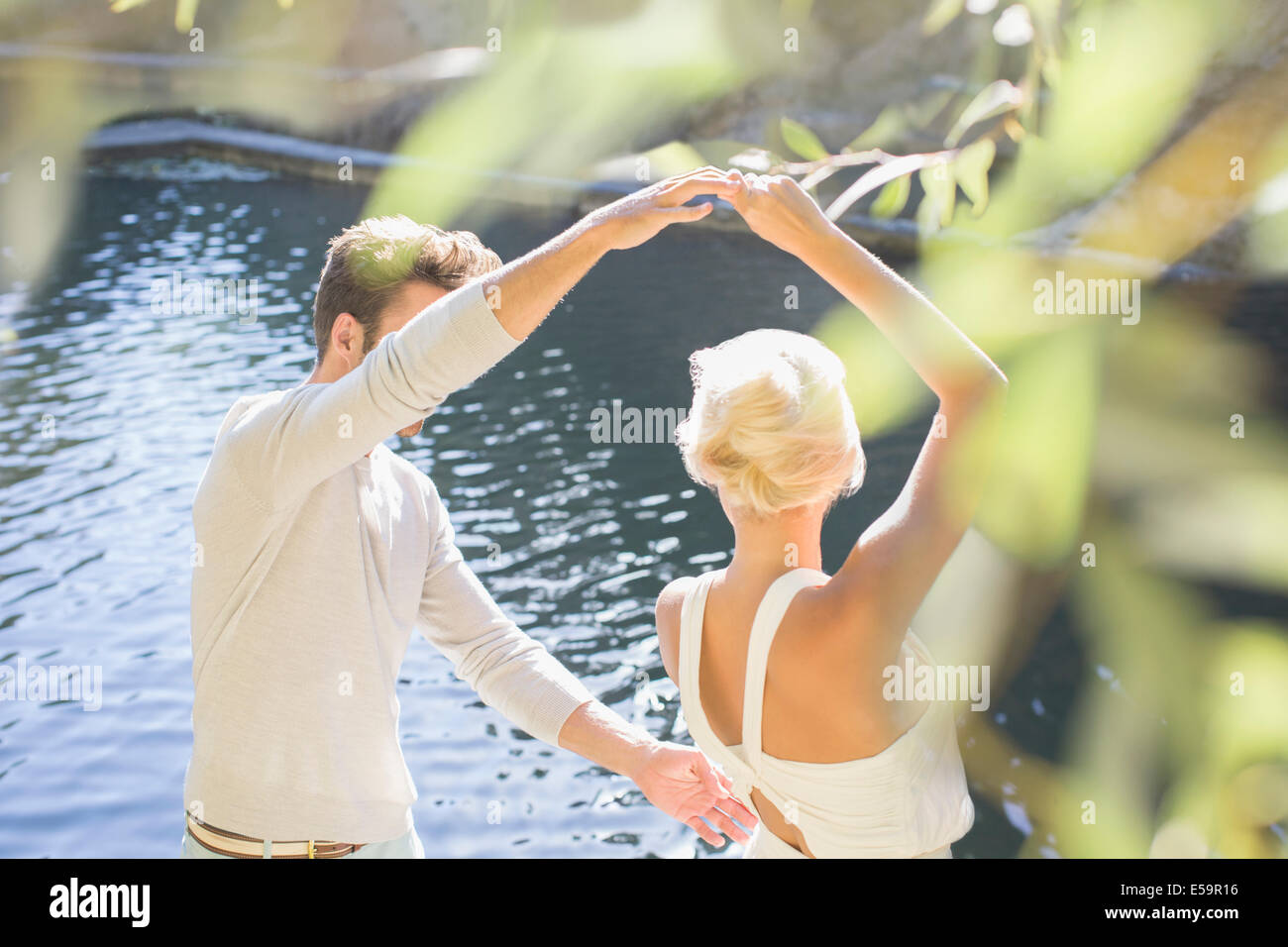 Couple dancing by pool Stock Photo - Alamy