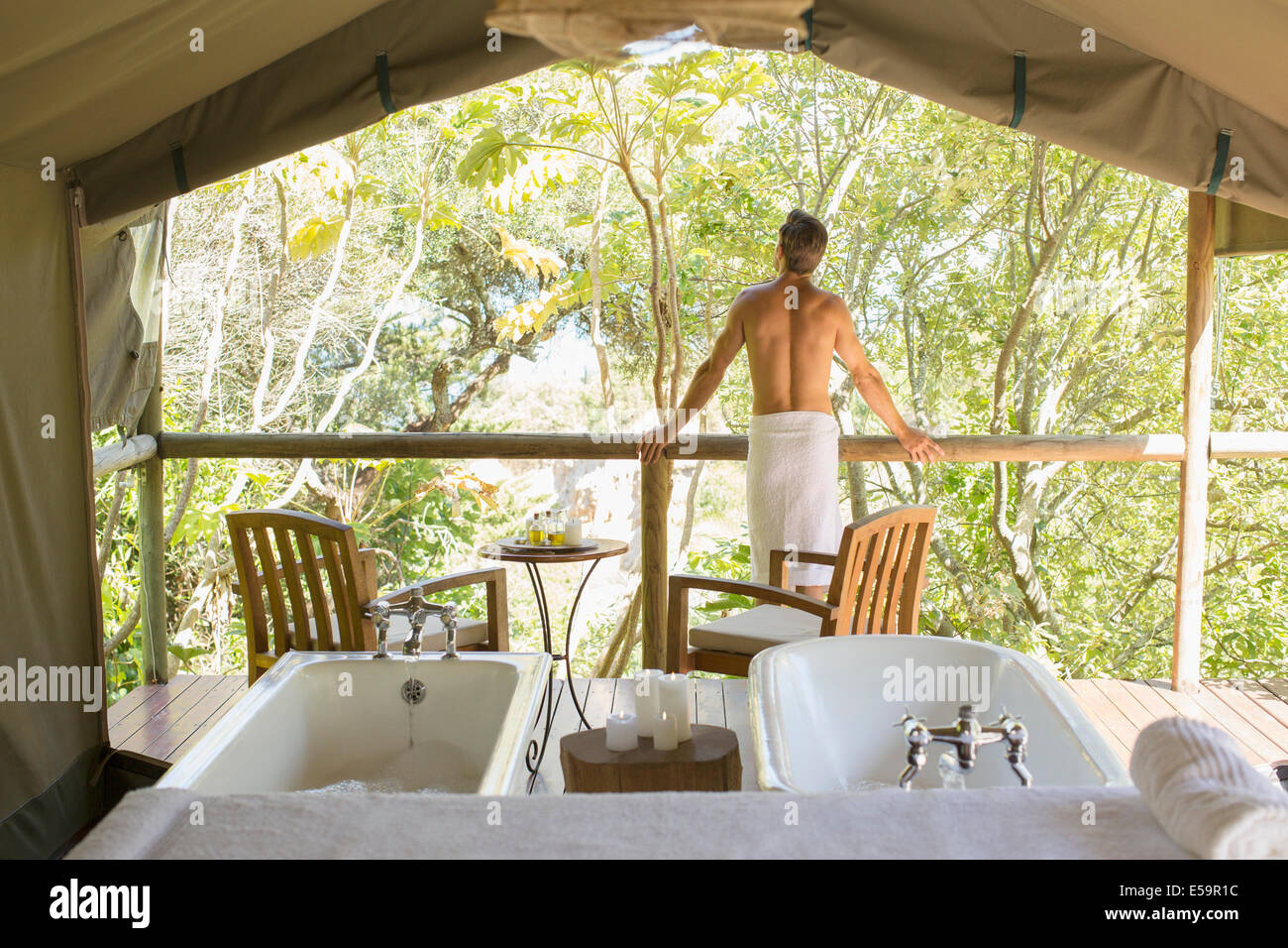 Man standing in ornate outdoor spa Stock Photo - Alamy