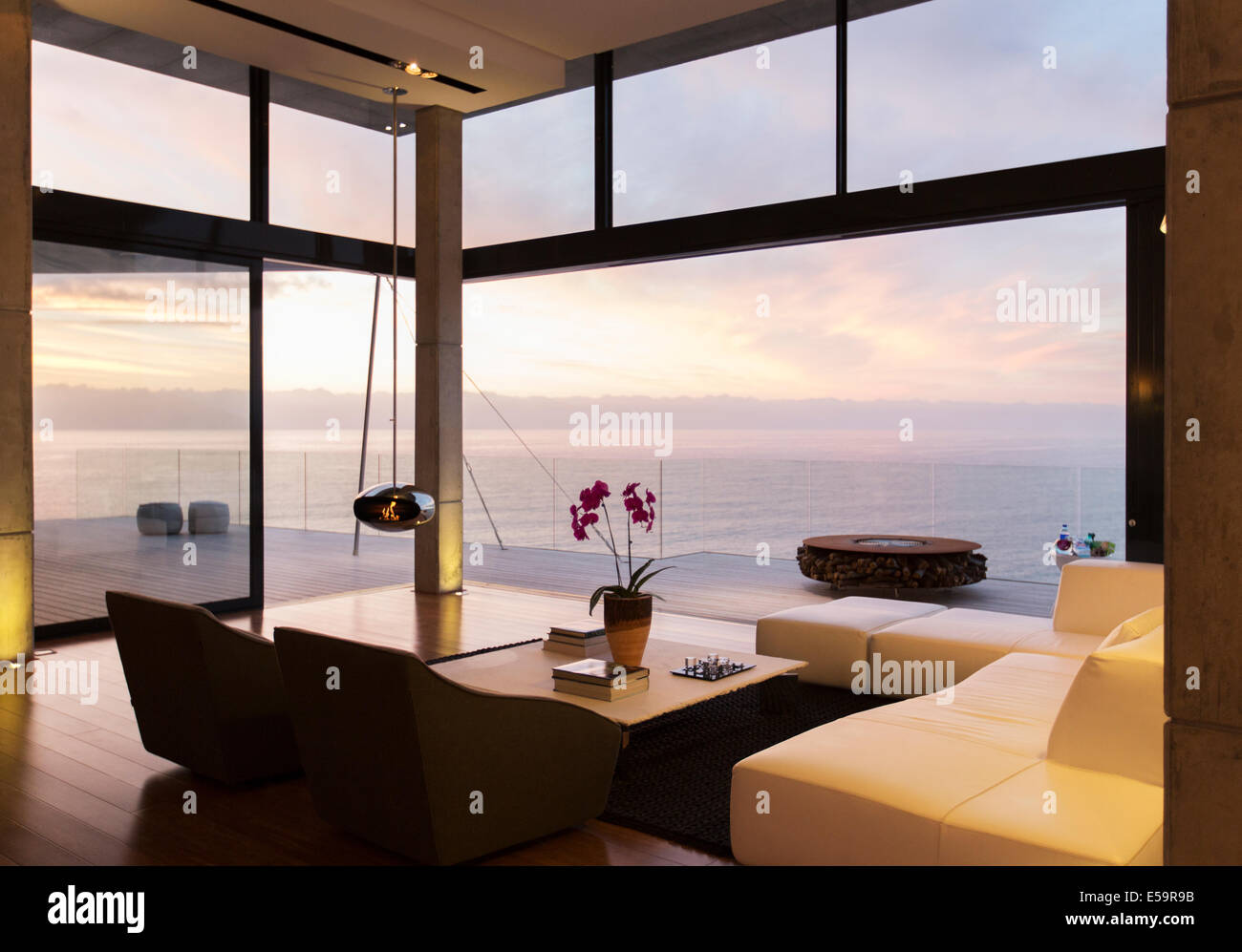 Modern living room overlooking ocean Stock Photo - Alamy