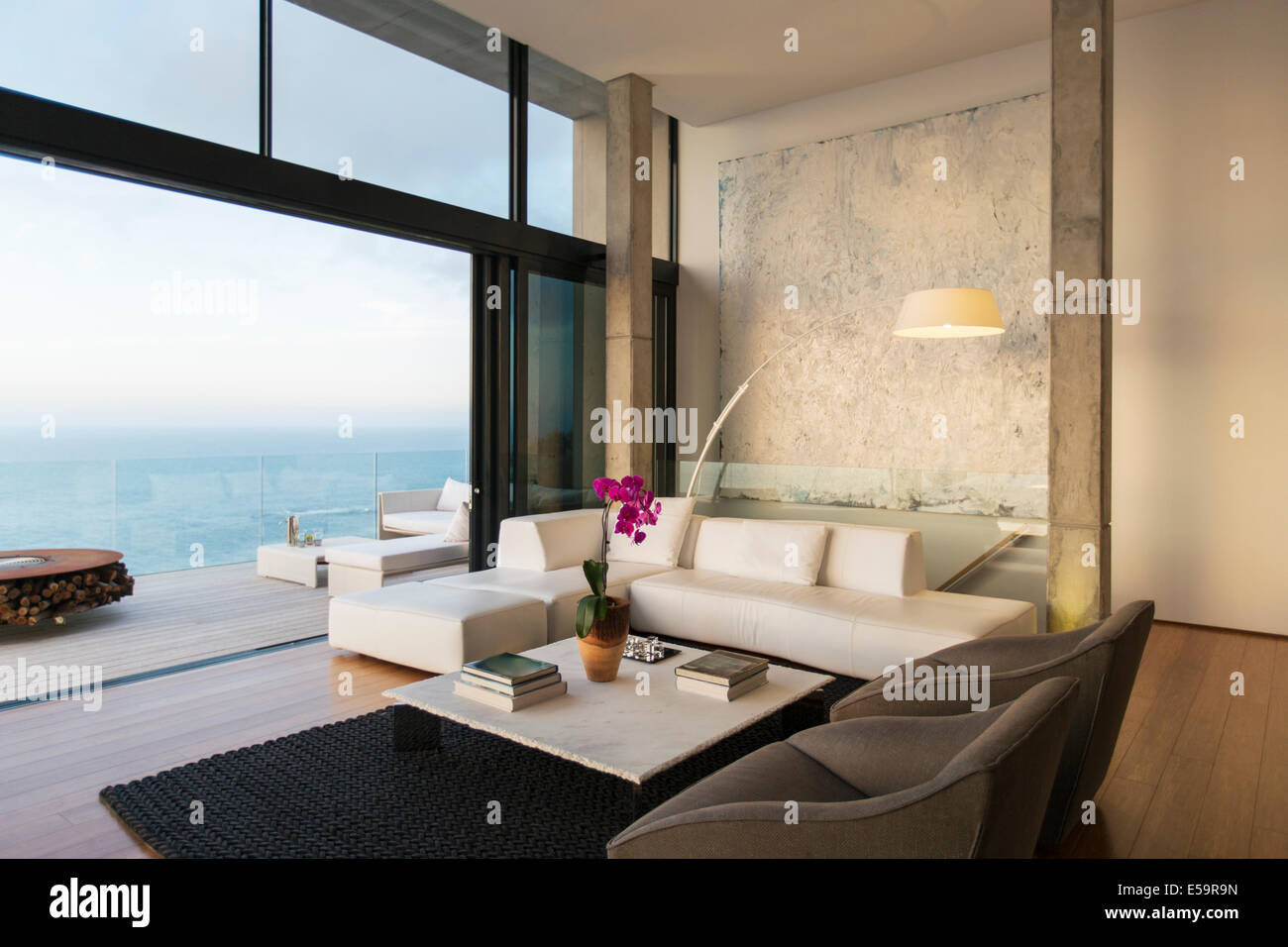 Modern living room overlooking ocean Stock Photo - Alamy